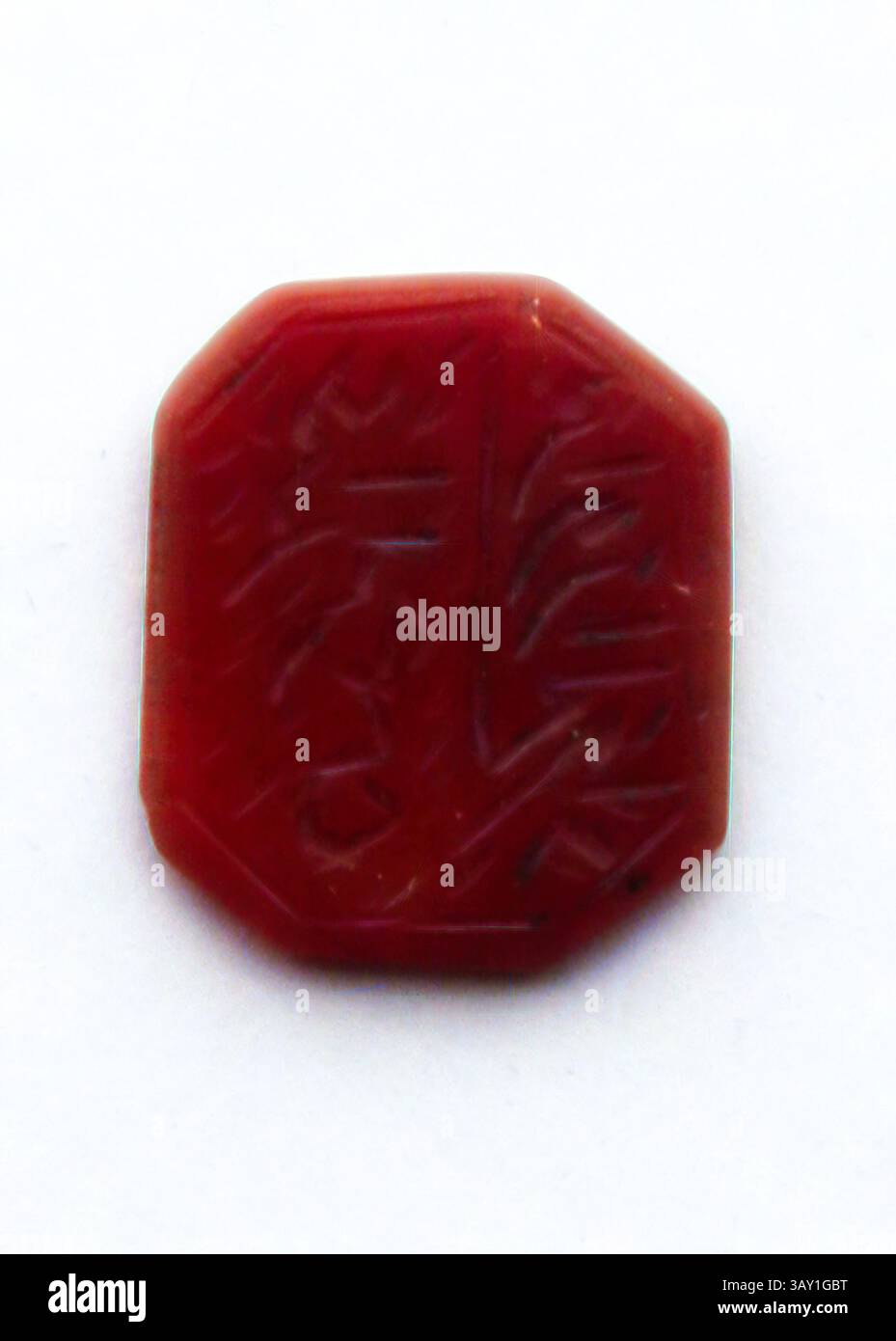An intricately carved red seal featuring stylized characters and ...