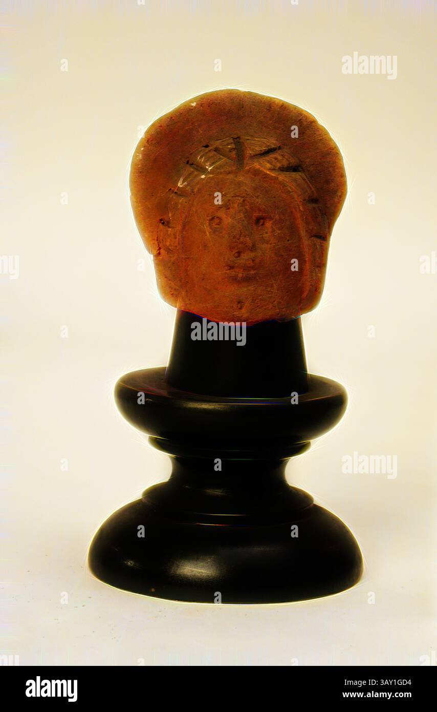 A carved stone head sits atop a polished black pedestal, showcasing ...