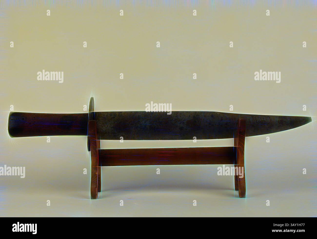 A long, slender blade rests atop a wooden stand, displaying its ...