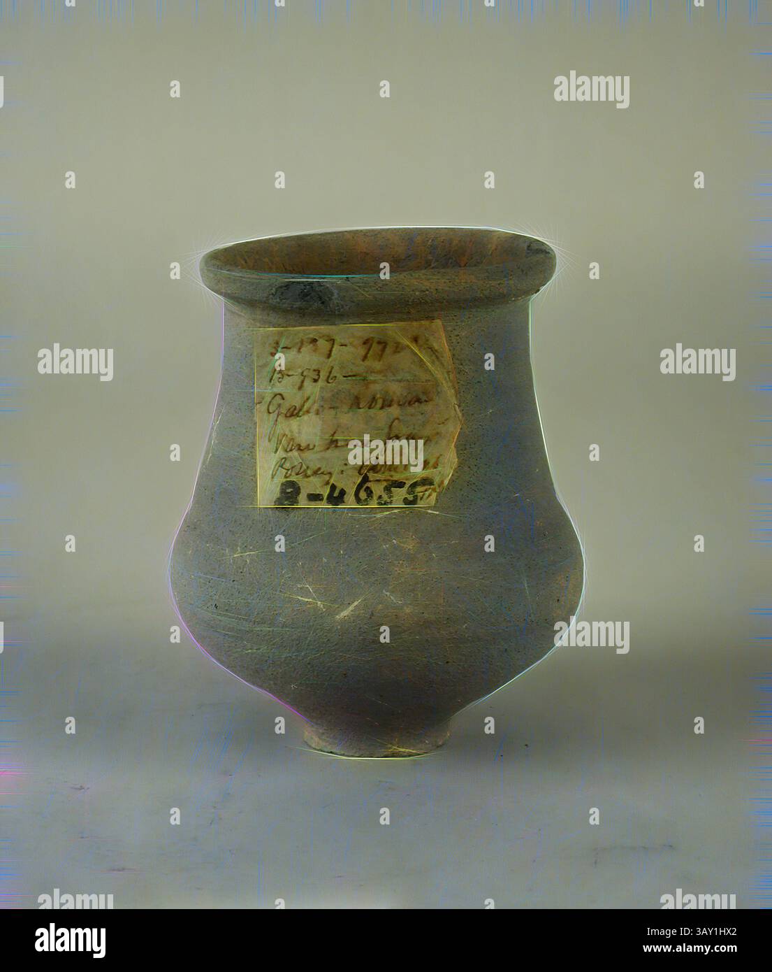 An ancient, rounded pottery vessel with a slightly flared rim, adorned ...
