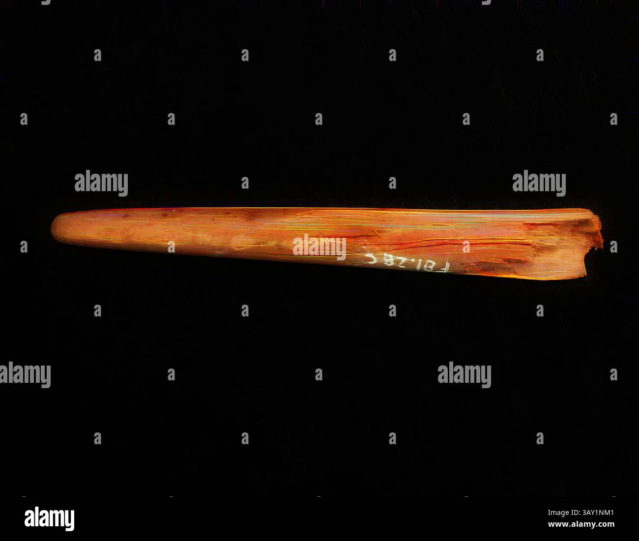 A carved wooden bat with a smooth finish, showcasing wear at one end ...