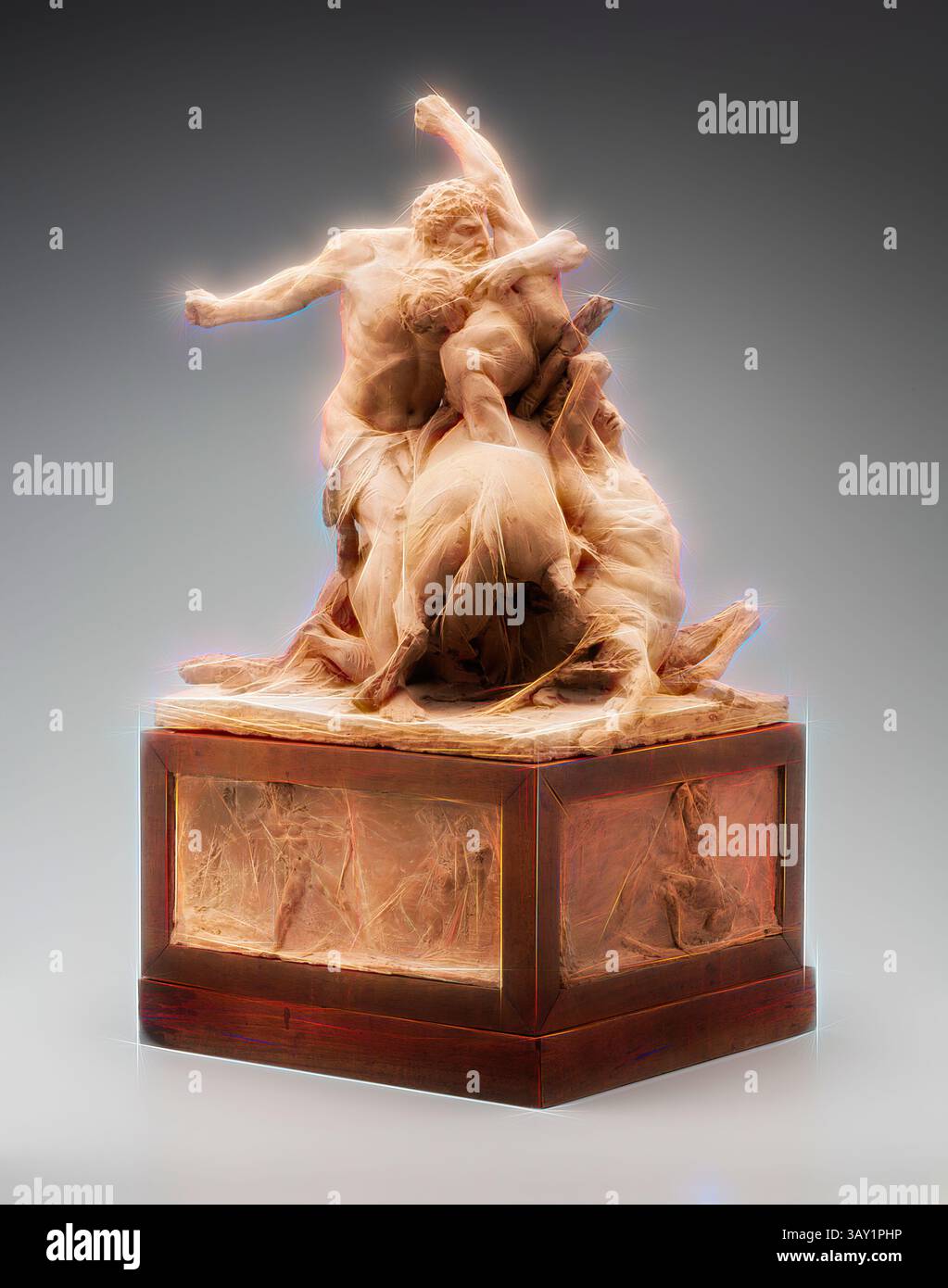 A dynamic sculpture depicts a dramatic struggle, with figures ...