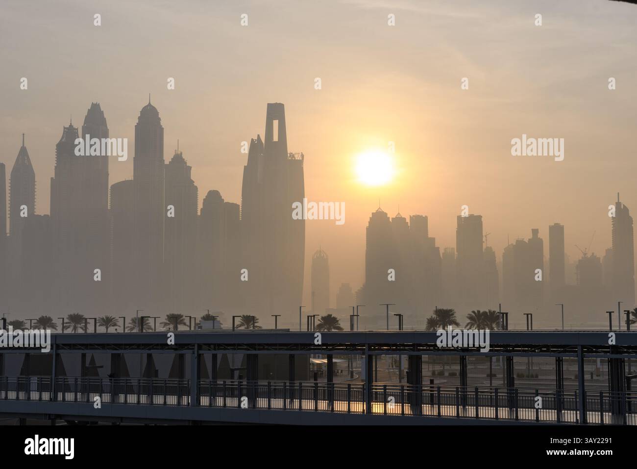 Dubai, UAE - December 31, 2024: The sun rises behind Dubai’s iconic ...