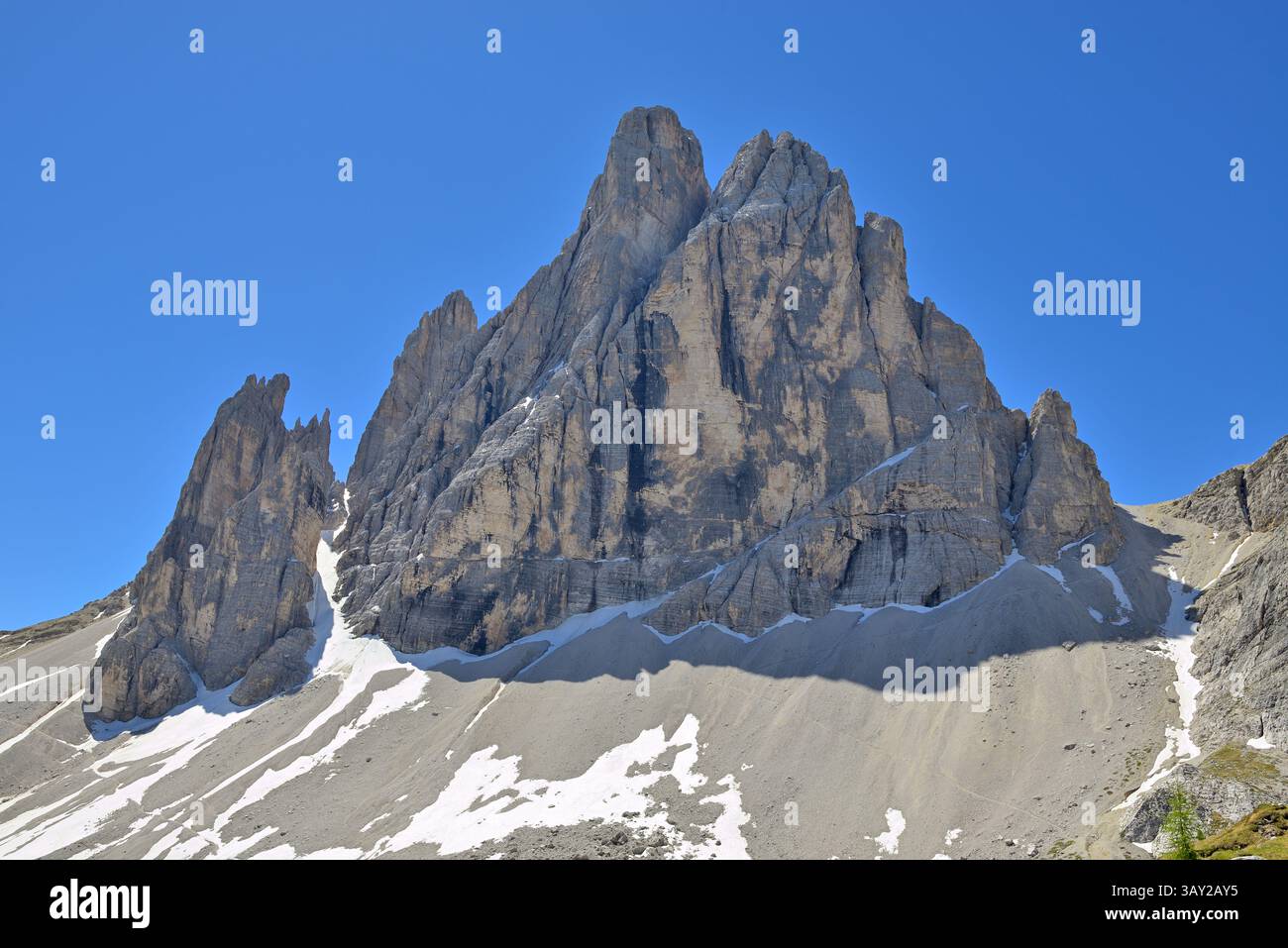 Mighty mountain massif against vibrant blue sky. Summit Cima Una is a ...