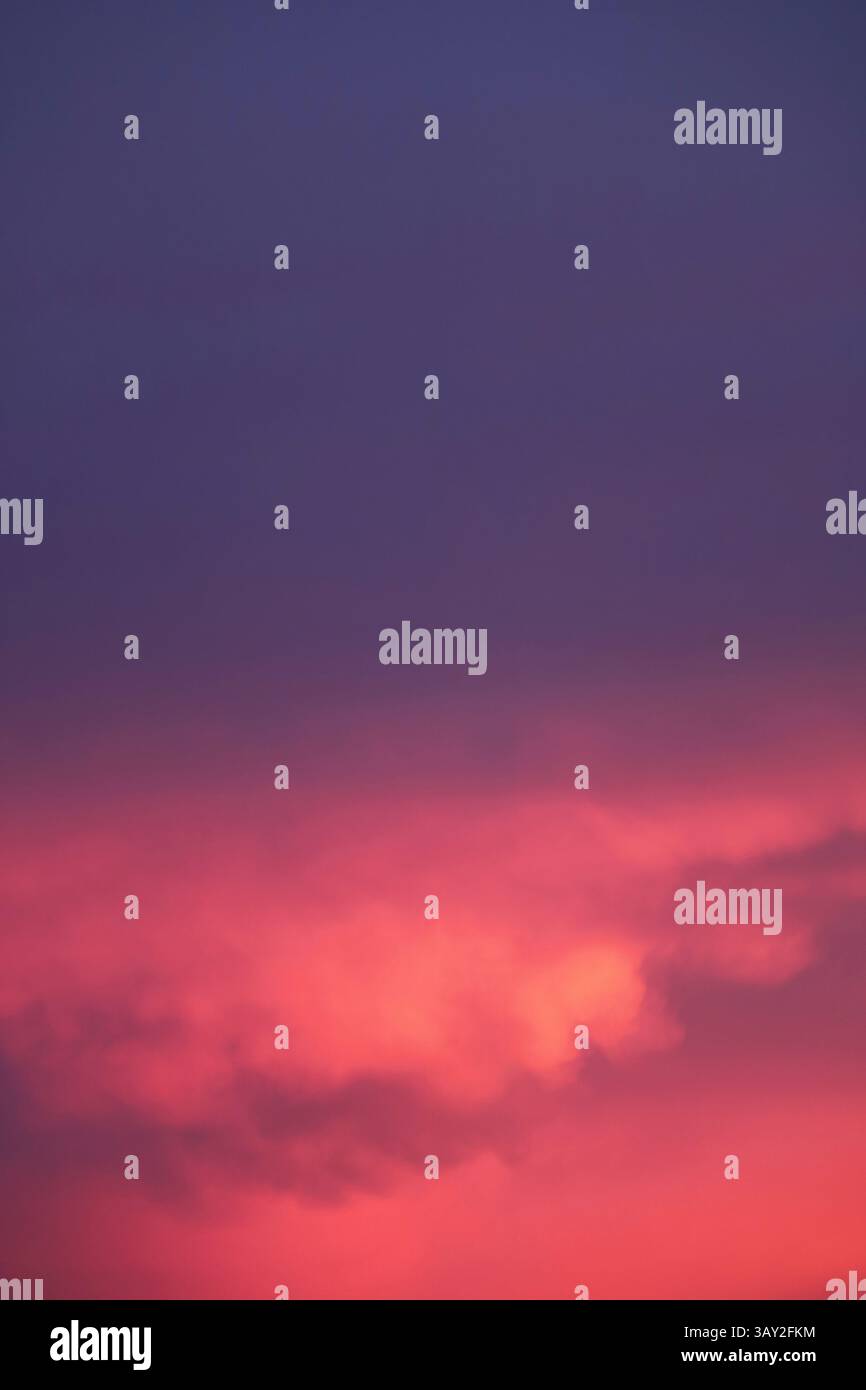 Deep Blue Dusk Sky with Coral Pink Afterglow Reflecting on the Clouds Stock Photo - Alamy