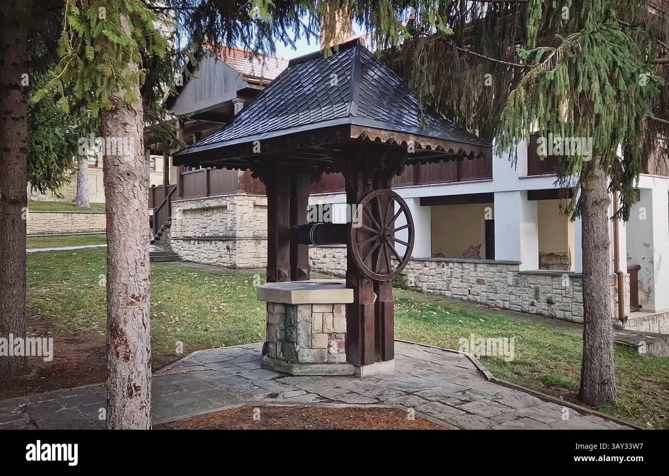 Traditional old well made of wood and stone, in the Capriana monastery ...