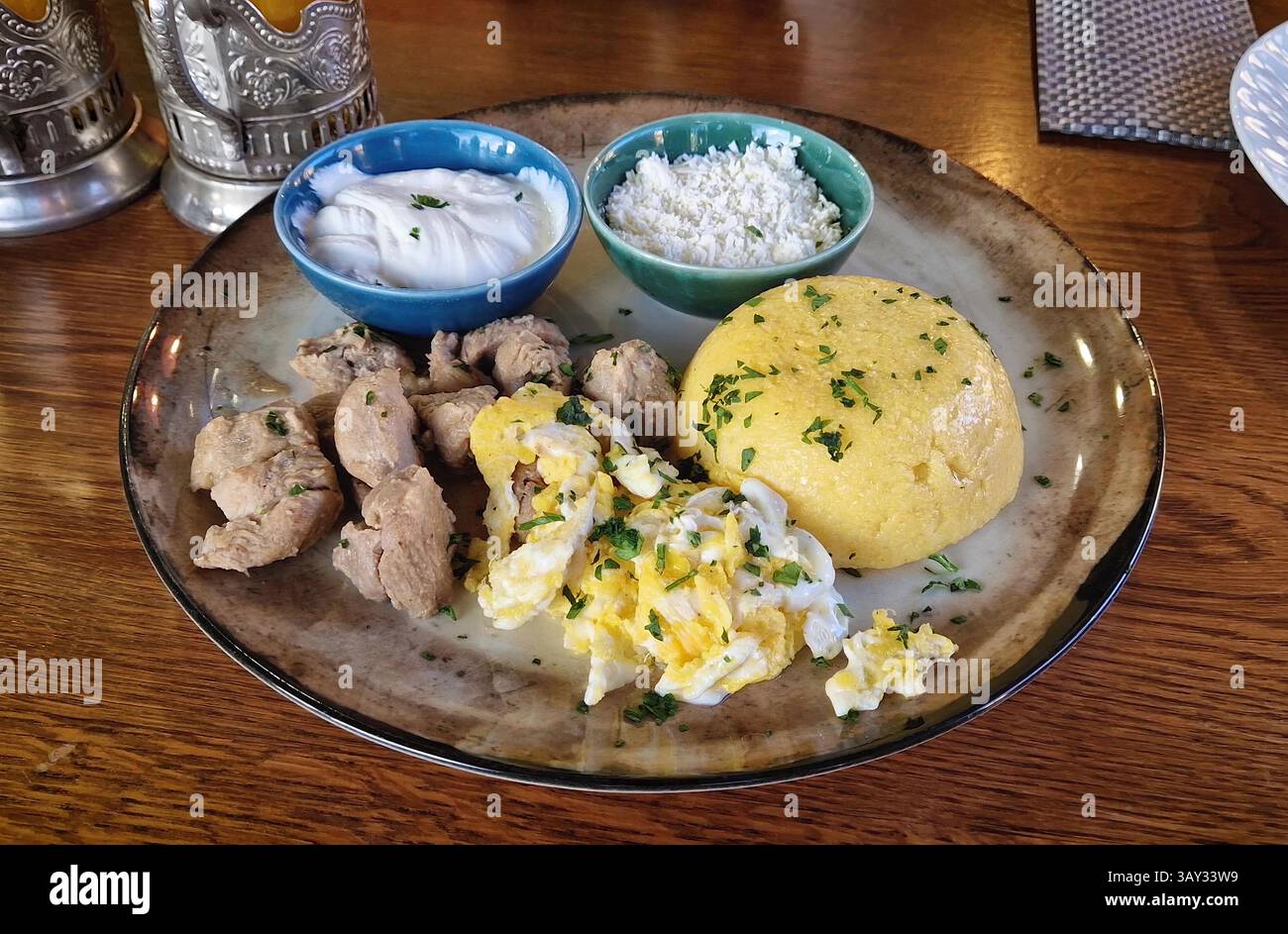 Traditional Moldovan food, meal closeup with pork stew, mamaliga ...