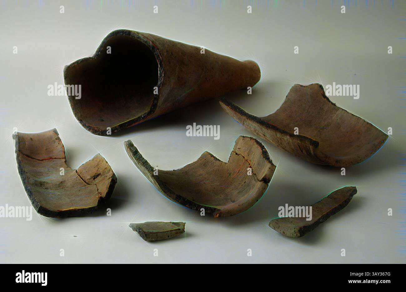 A collection of ancient pottery fragments, showcasing various shapes ...