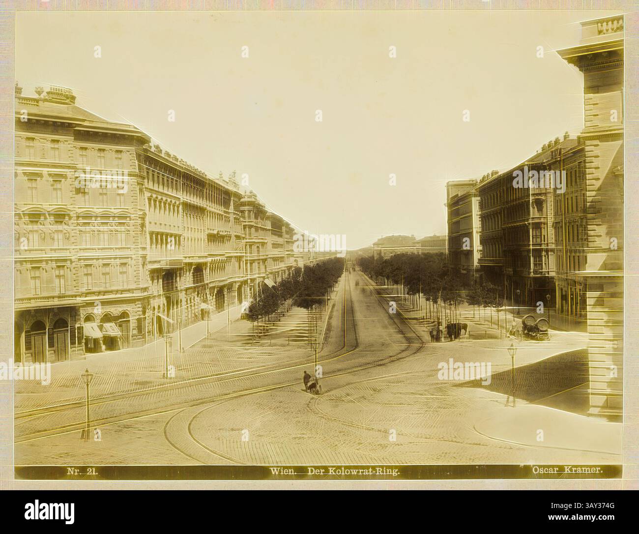 A wide street scene featuring elegant buildings along both sides, with ...