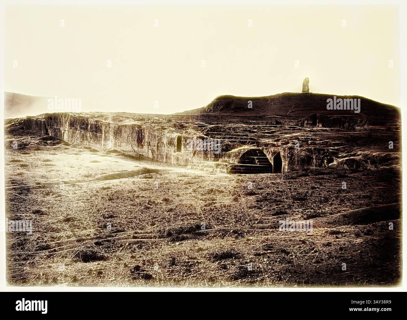 A desolate landscape features ancient ruins, with weathered stone ...