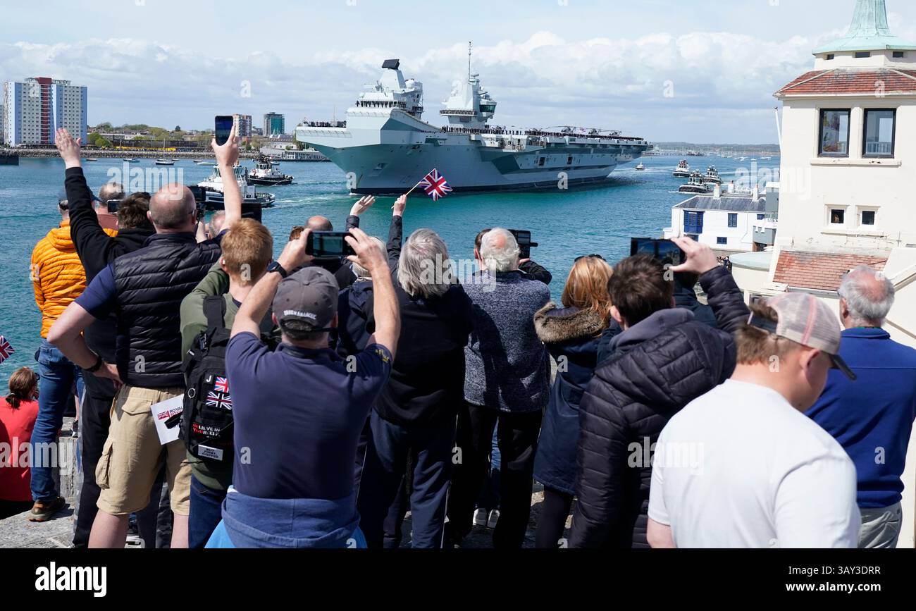 People wave from the Round Tower as the Royal Navy aircraft carrier ...