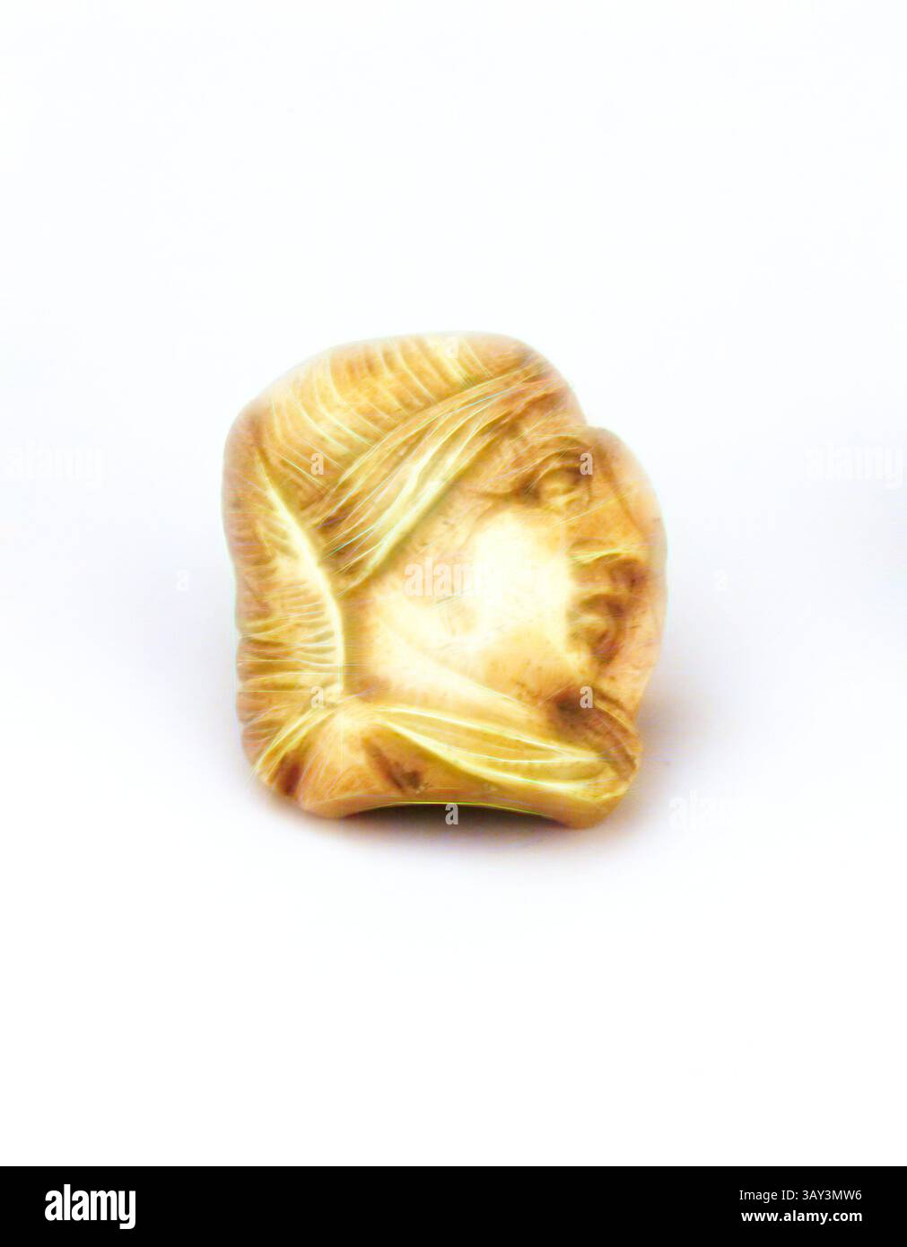 A finely carved stone sculpture depicting a profile of a woman's face ...