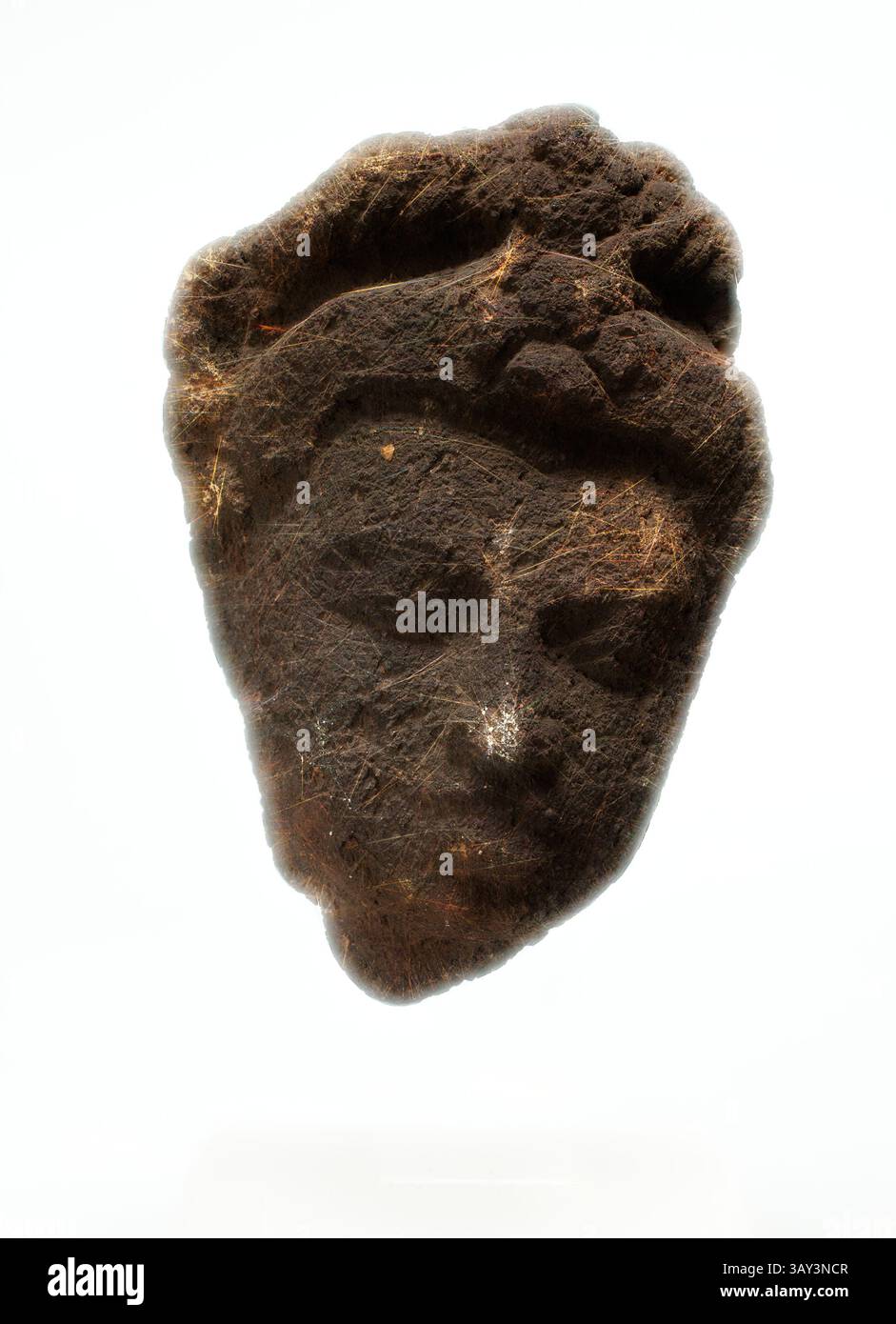 An ancient stone sculpture depicting a stylized human face, featuring ...