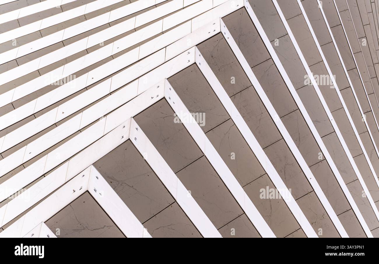 Close-up of a modern architectural facade featuring diagonal lines creating a dynamic pattern ...