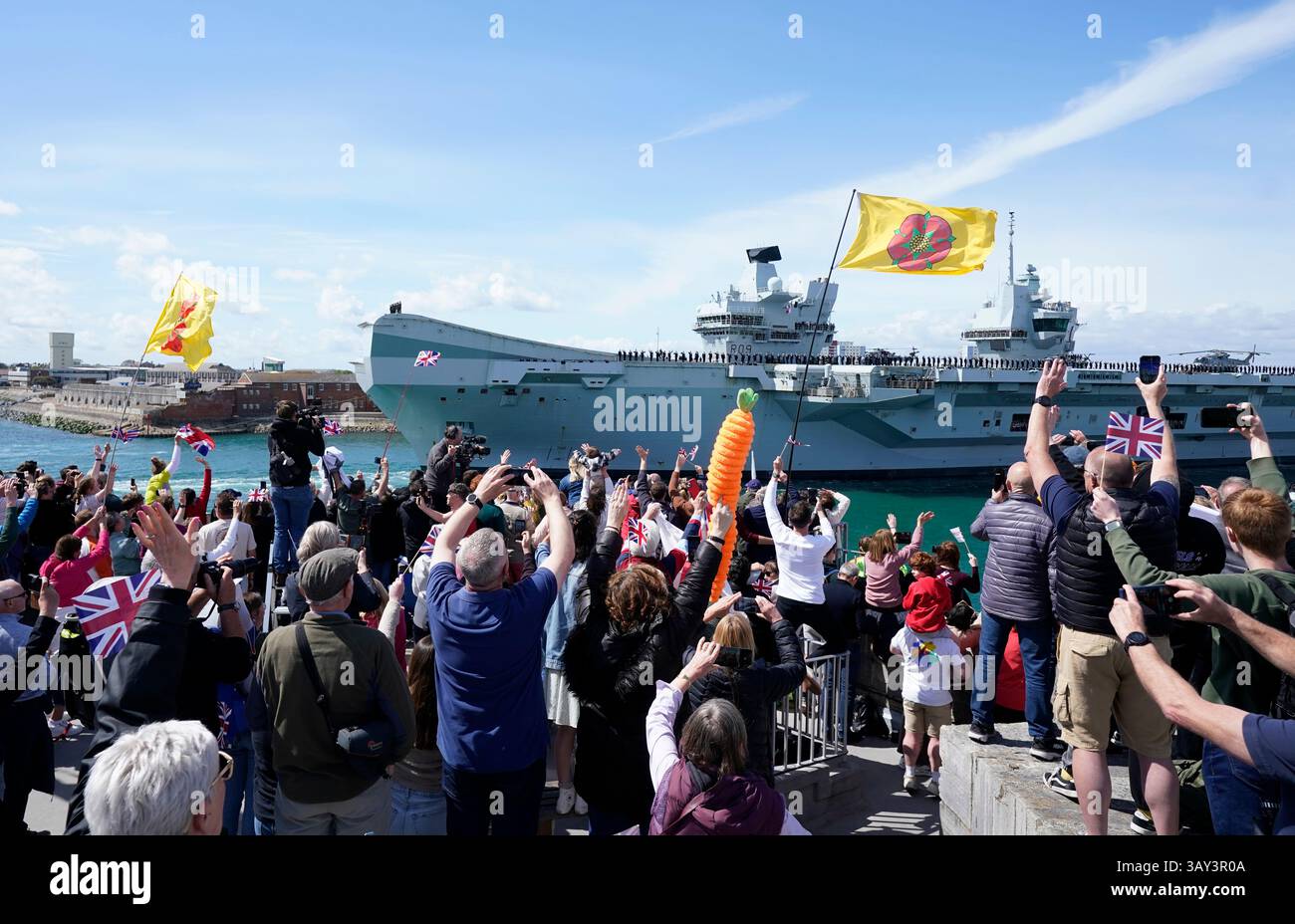 People wave from the Round Tower as the Royal Navy aircraft carrier ...
