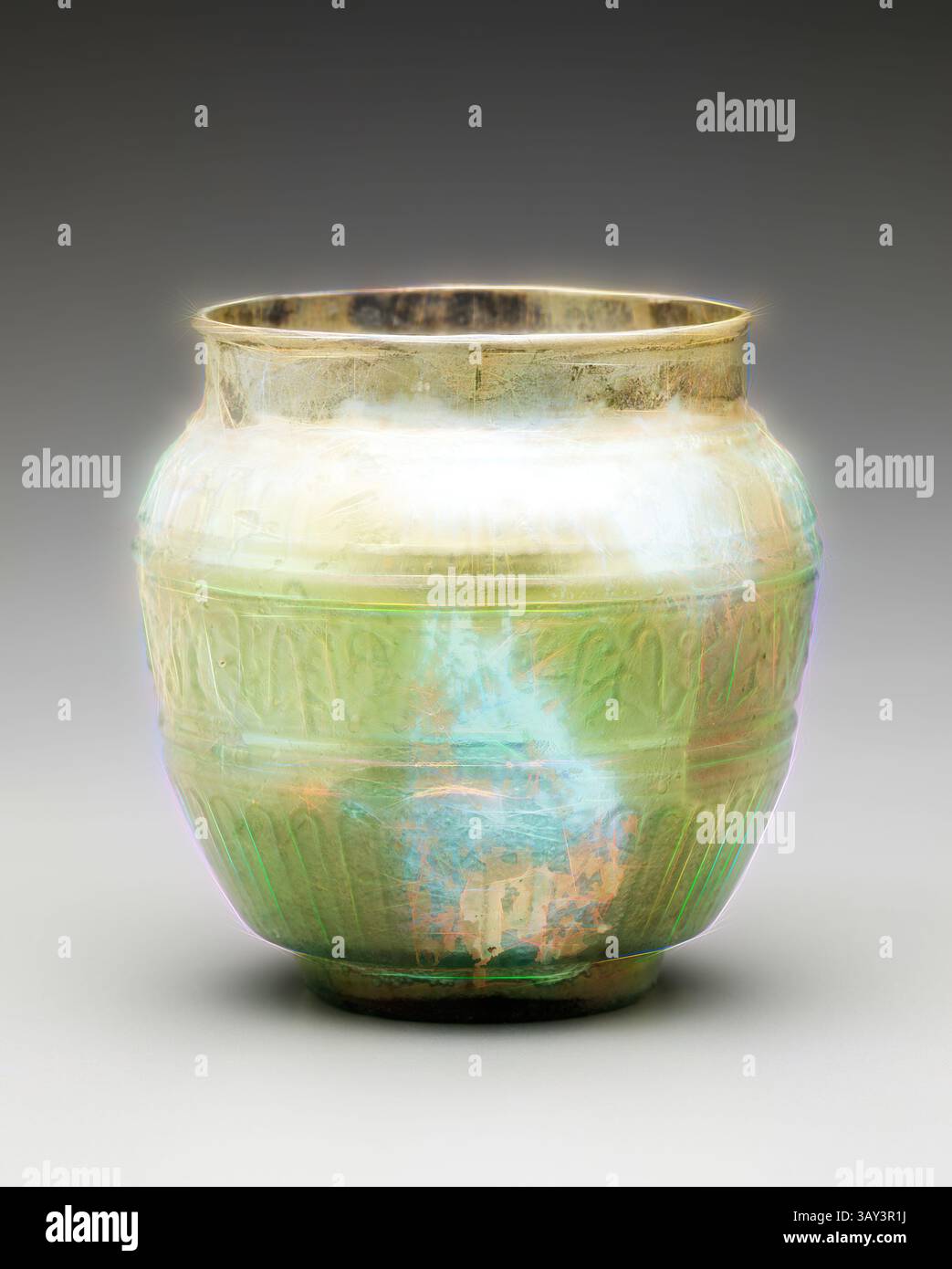 An intricately designed pottery vessel featuring a blend of vibrant ...