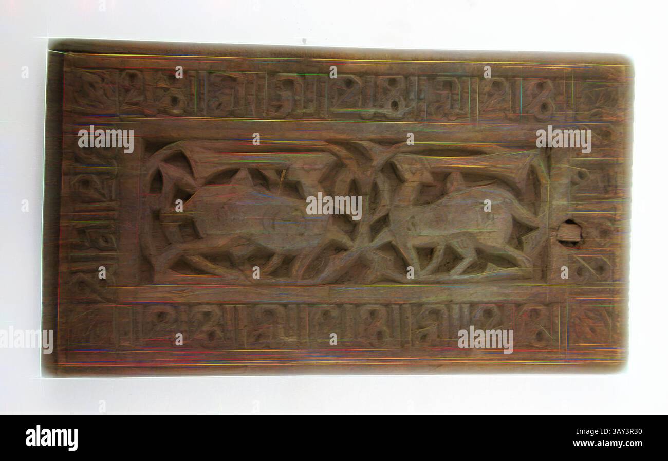 An ornate carving featuring a symmetrical design with two stylized ...