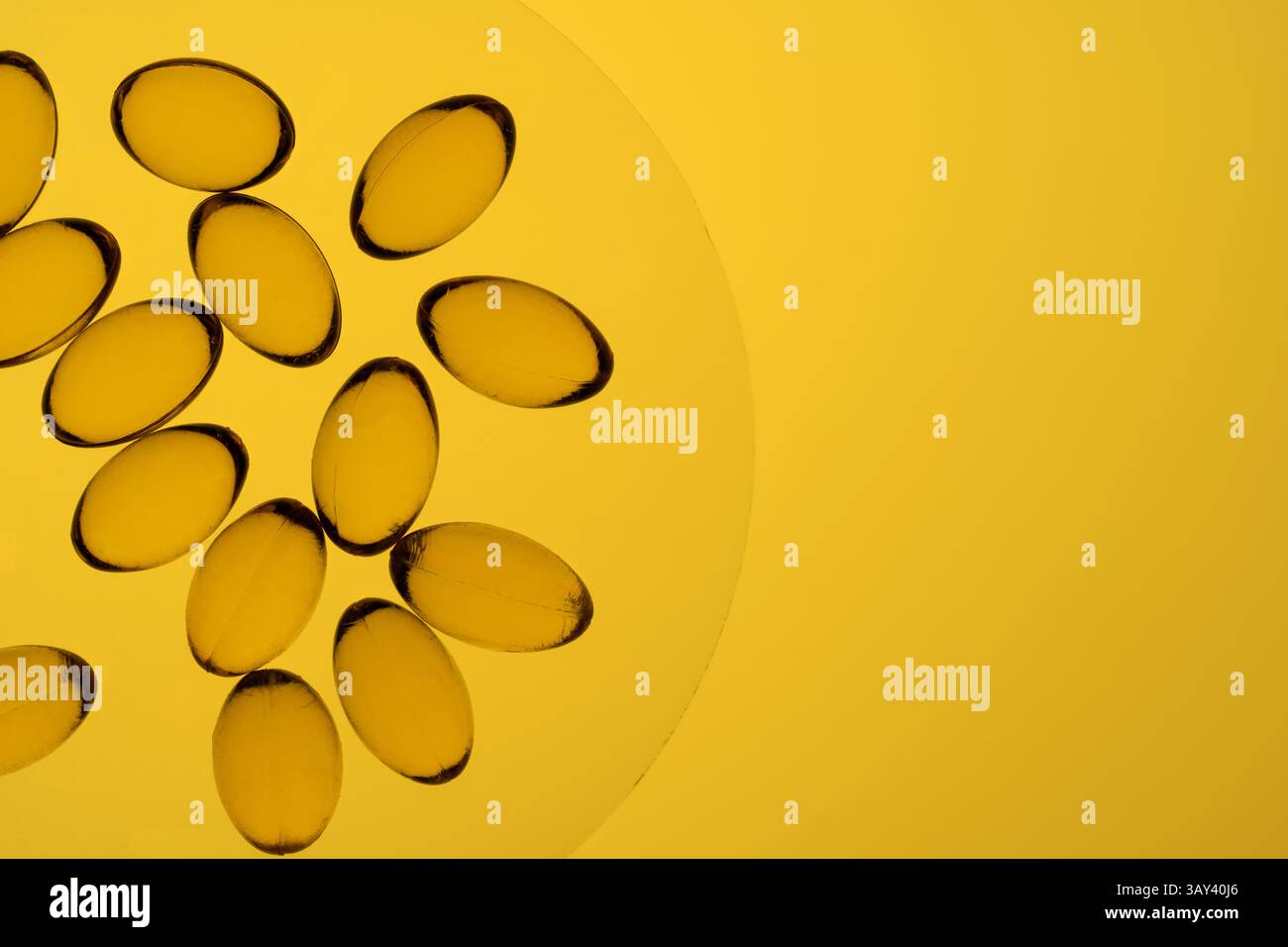 A striking image featuring several Omega-3 and Vitamin D capsules ...
