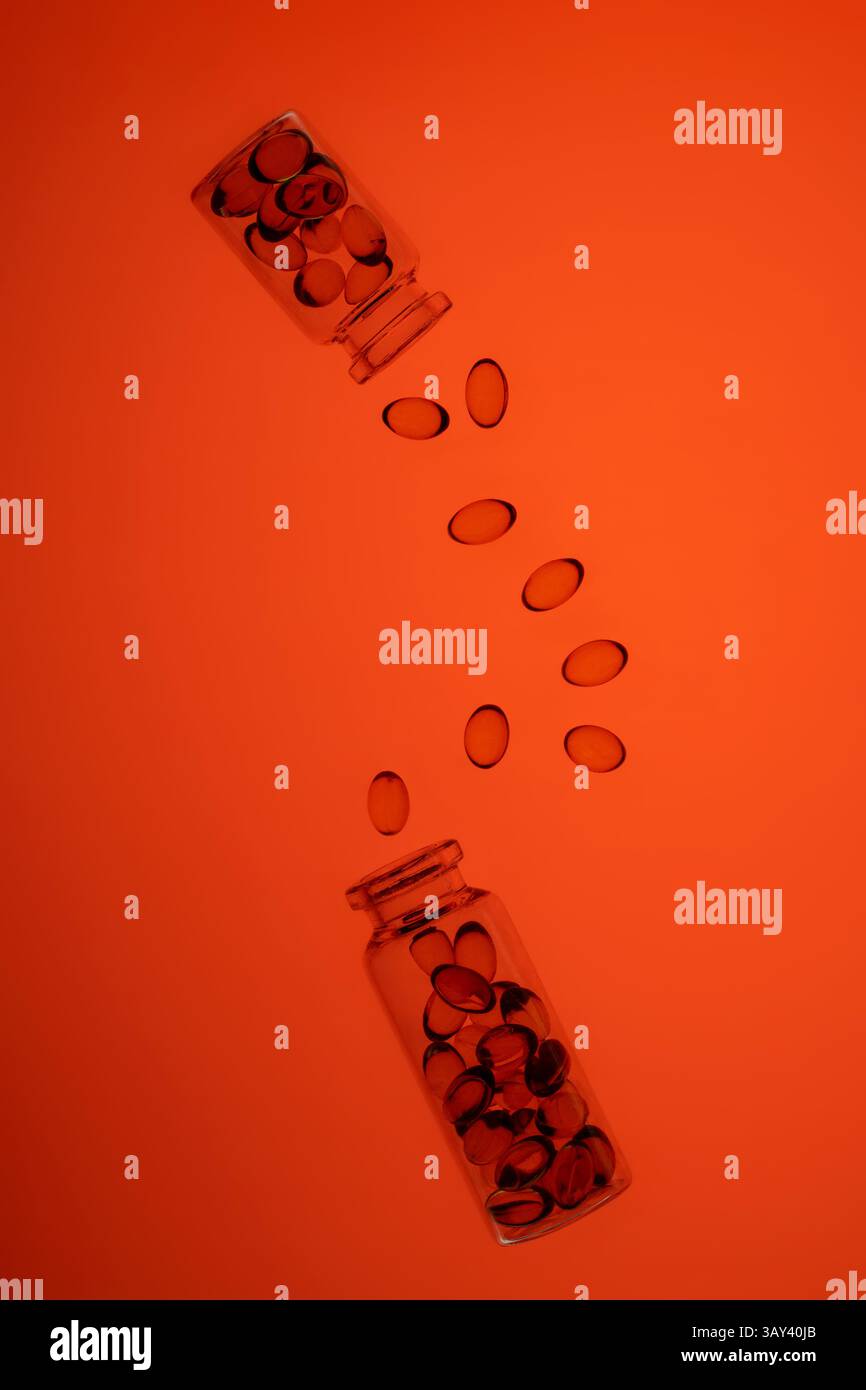 Glass jars filled with colorful omega-3 and Vitamin D capsules are ...