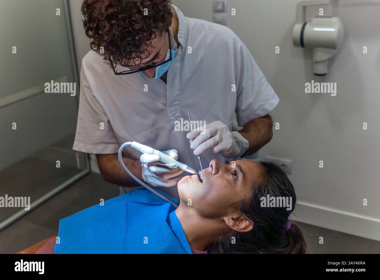 Dentist conducts teeth cleaning hi-res stock photography and images - Alamy
