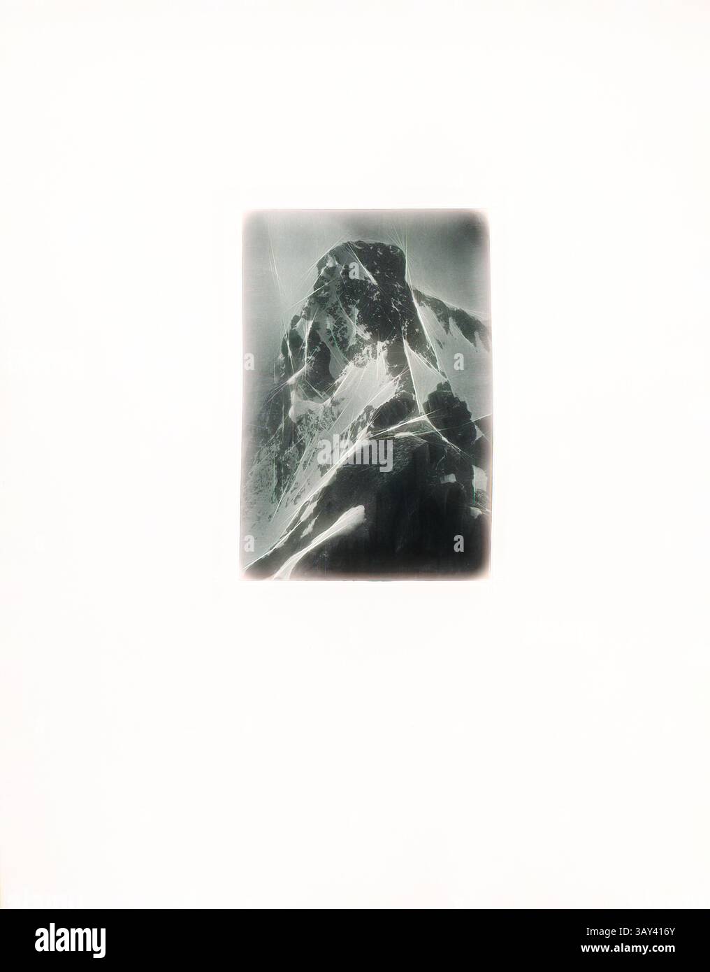 A towering mountain peak rises dramatically, cloaked in snow, with ...