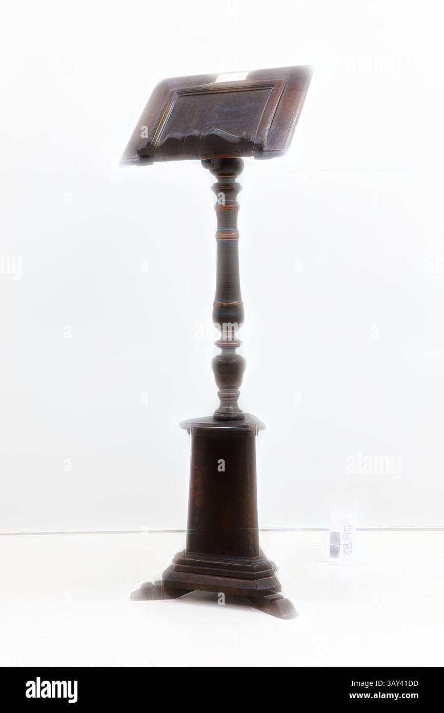 A vintage lectern stands tall, featuring a curved reading surface and a ...