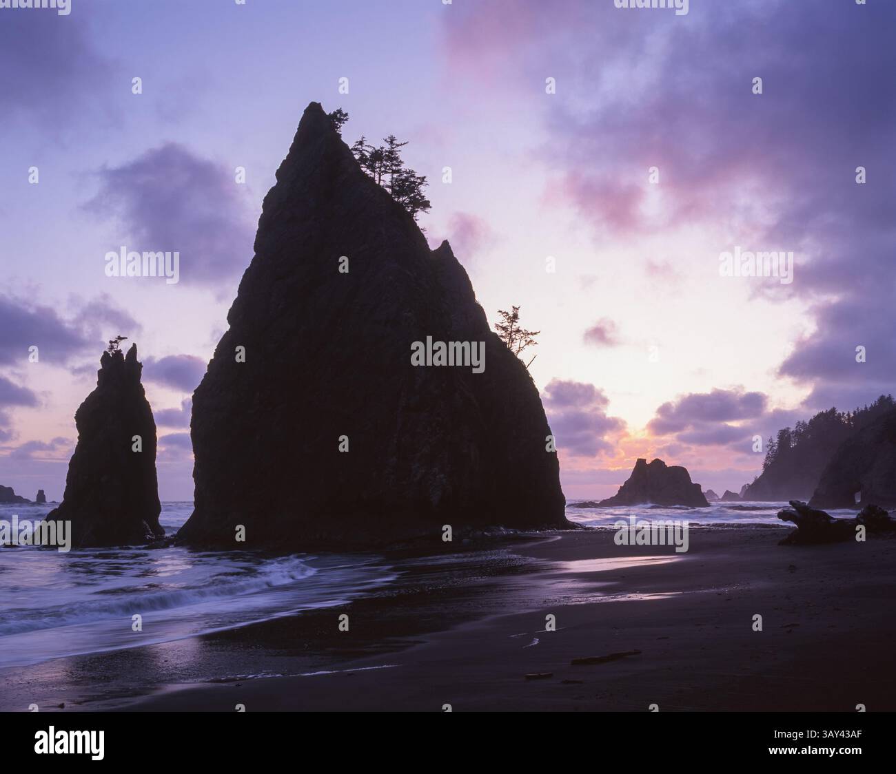 Stunning coastal scene featuring tall, jagged sea stacks silhouetted ...