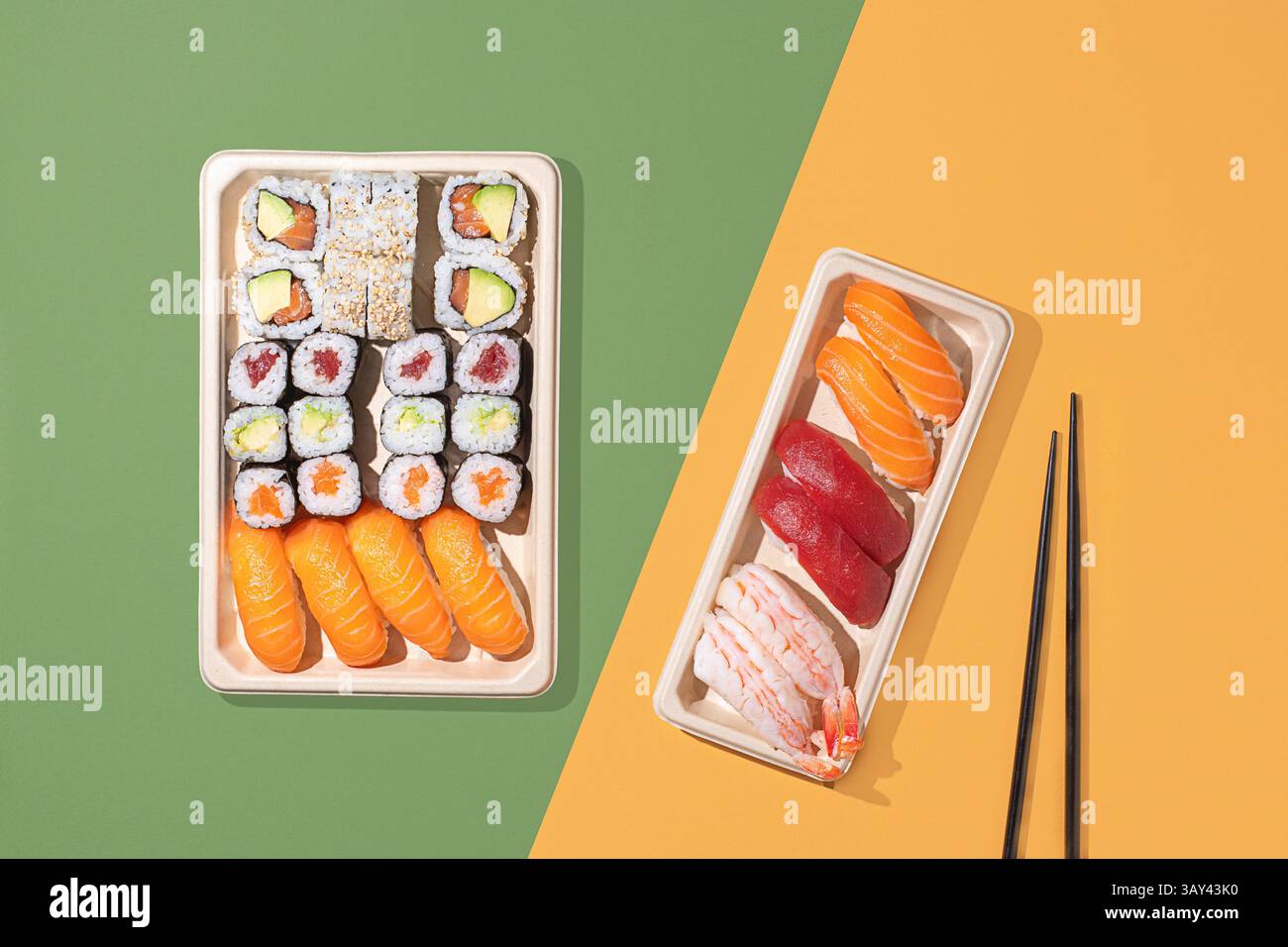 Top down view of assorted sushi in eco friendly trays, set against a ...