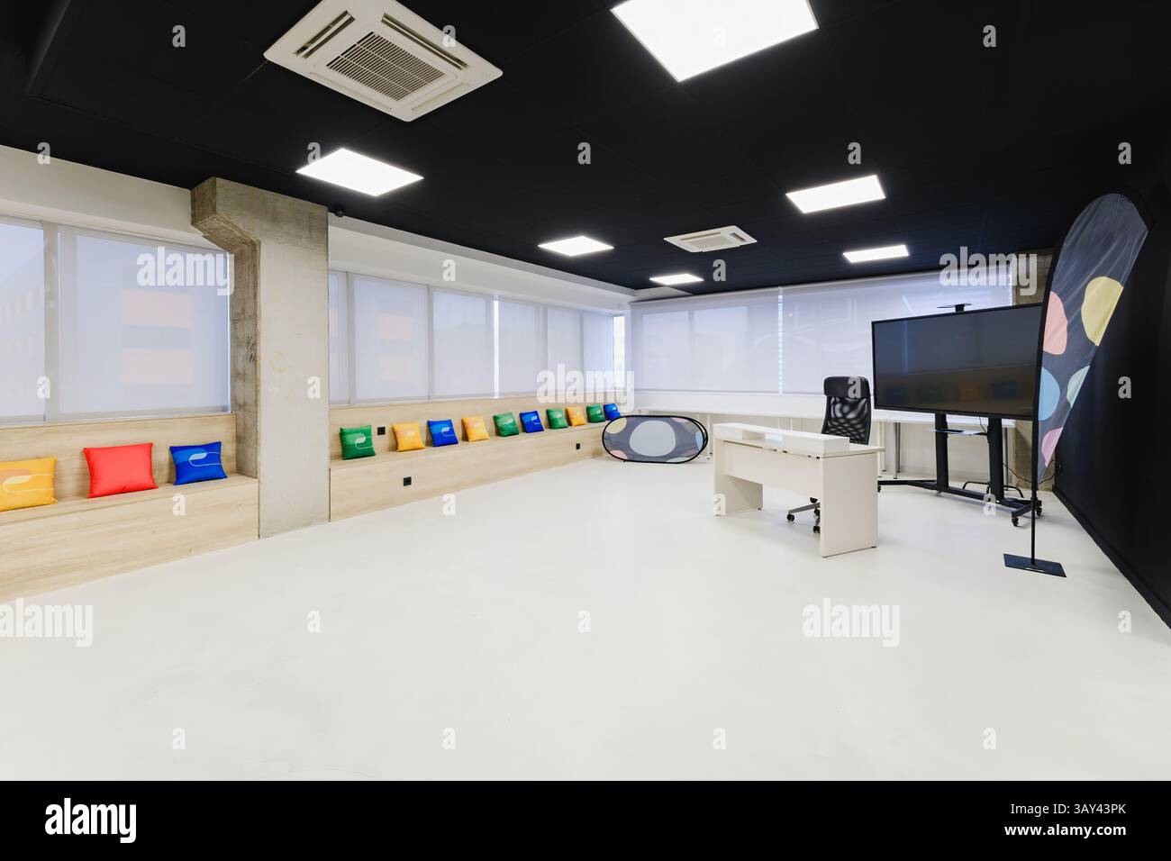 Modern and spacious training room featuring a long bench with colorful ...