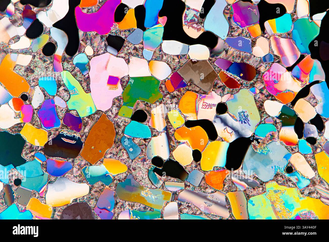 Liquid crystals under a microscope, featuring a vivid array of colors ...