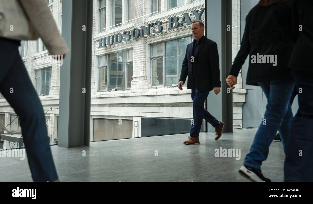 Calgary, Canada. 20th Mar, 2025. Pedestrians pass the Hudson's Bay ...