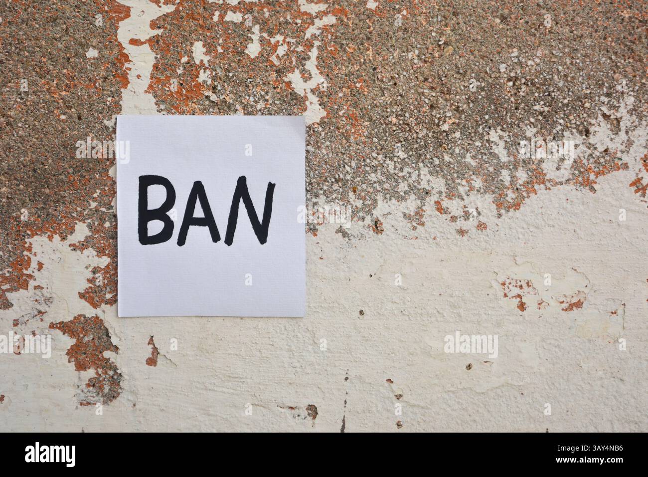 Paper note written with BAN on old wall Stock Photo - Alamy