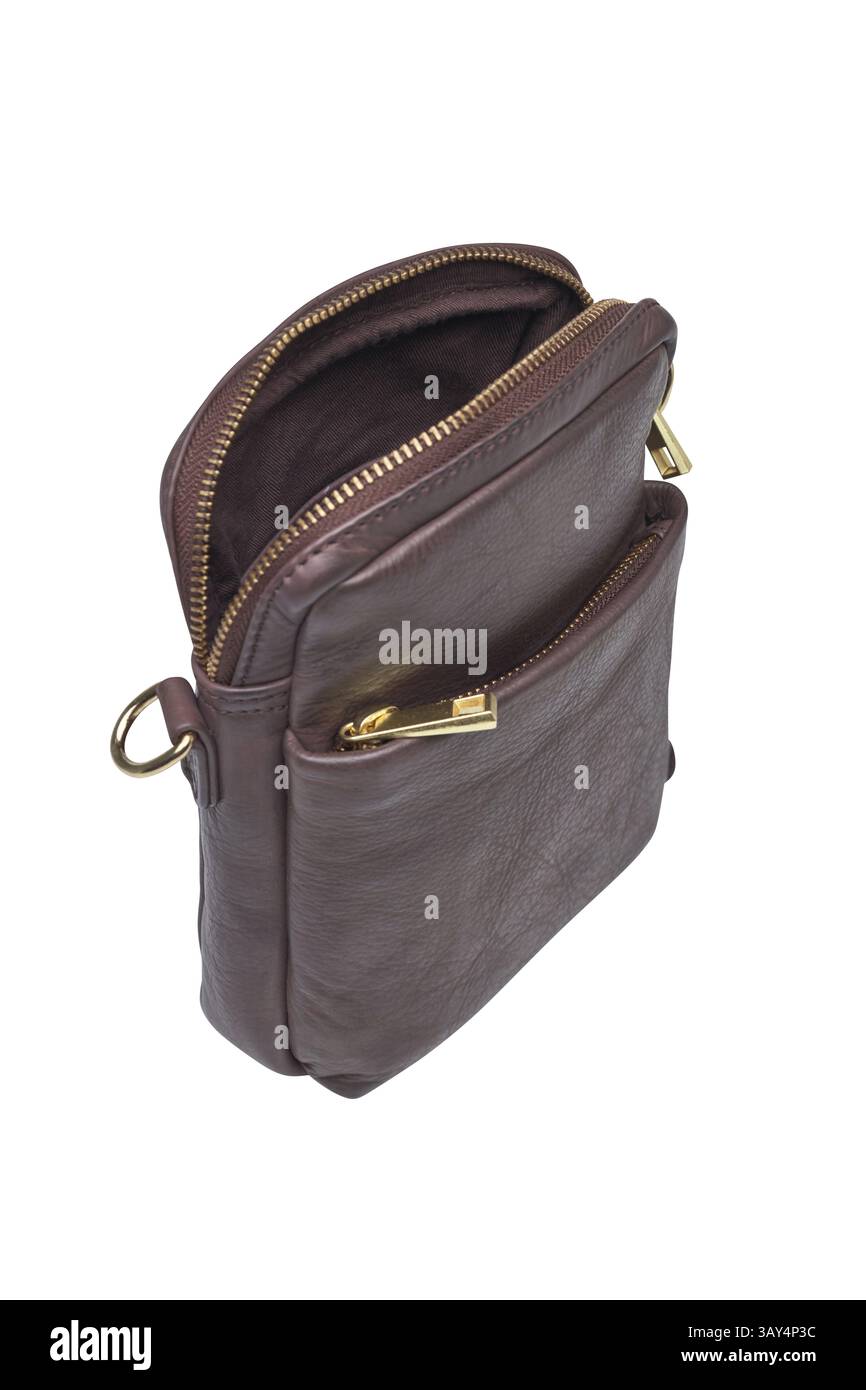 an open brown leather crossbody bag with gold zippers sits on a white ...