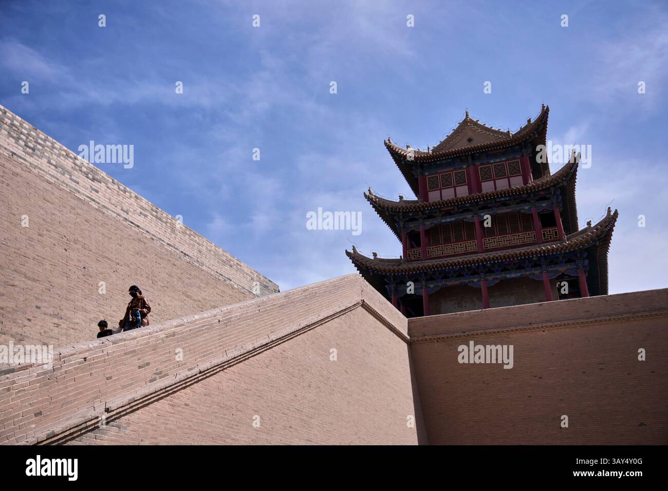 A woman and a child tour Jiayu Pass, a strategic point of the Great ...