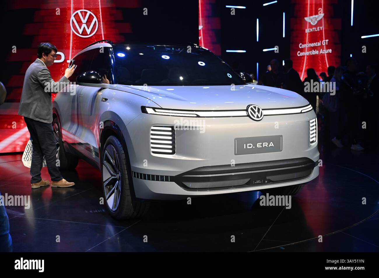 dpatop - 22 April 2025, China, Shanghai: A man looks at the Volkswagen ...