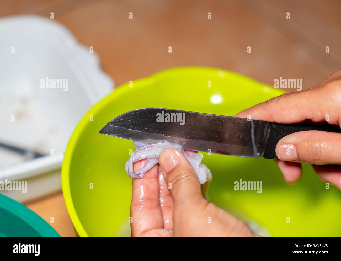 Use a knife to cut open the squid and remove the eyes before cooking ...