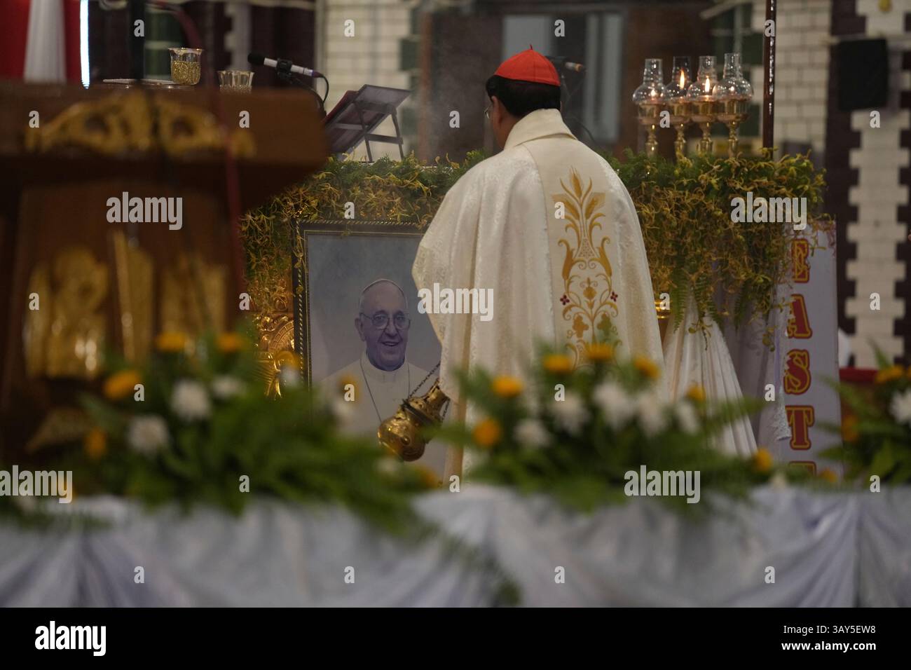 Cardinal Charles Maung Bo prays in front of portrait of Pope Francis at ...