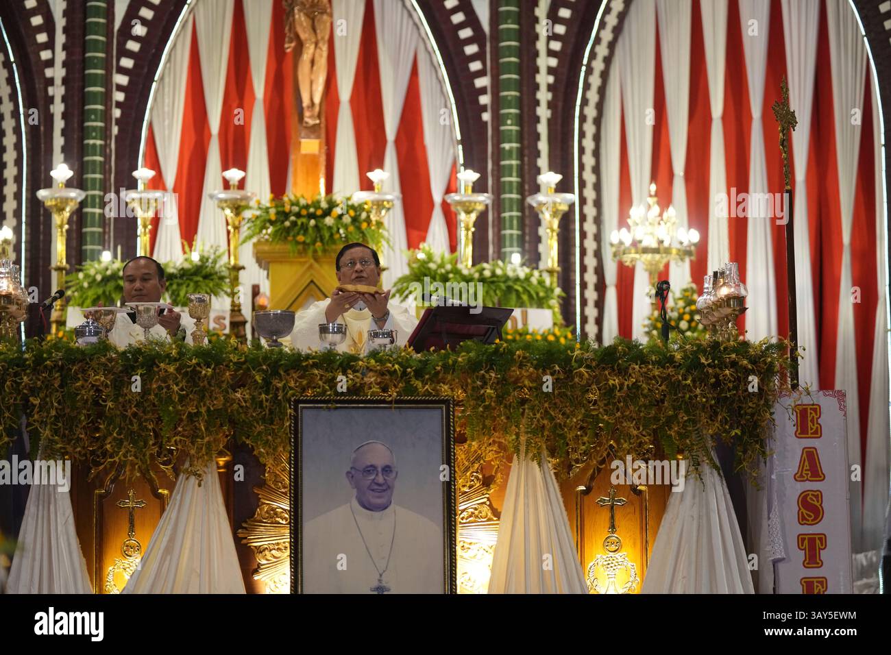 Cardinal Charles Maung Bo prays while portrait of Pope Francis ...