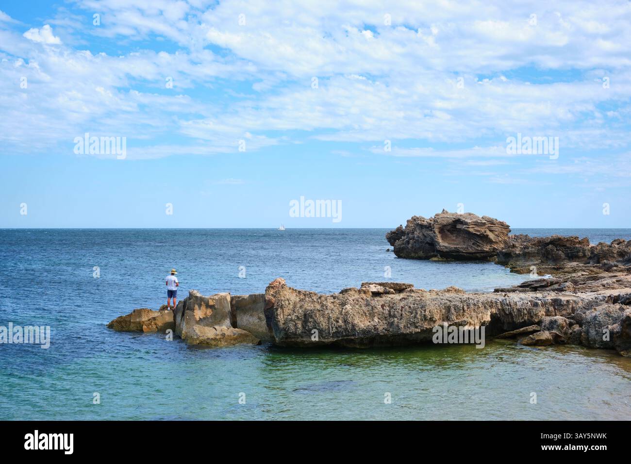 A man fishing from limestone rocks at Point Peron, Cape Peron Coastal ...