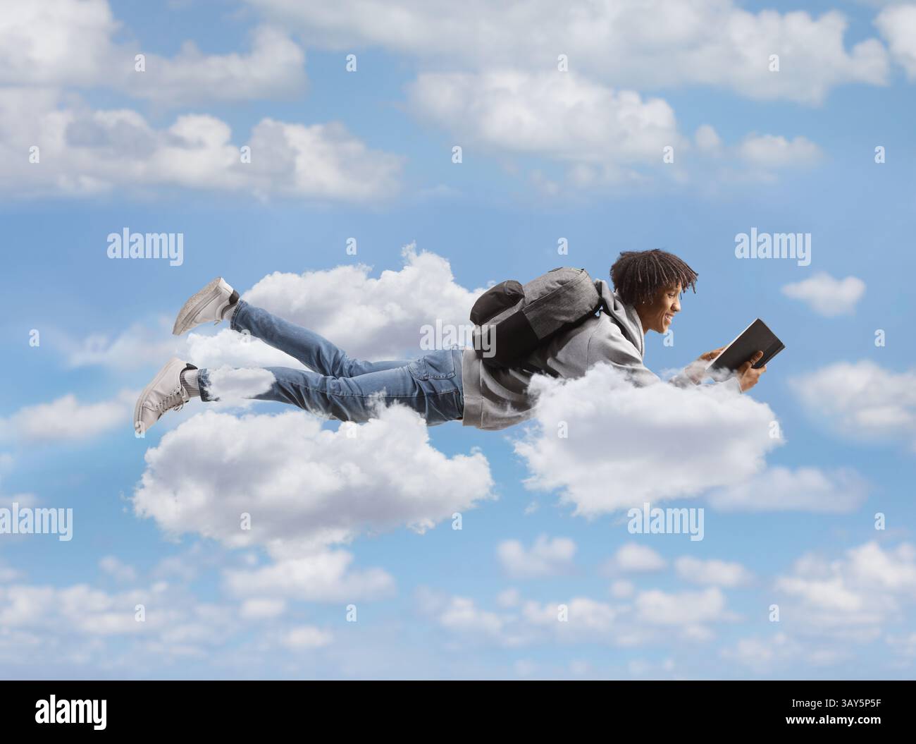 African american male student flying in the sky and reading a book ...