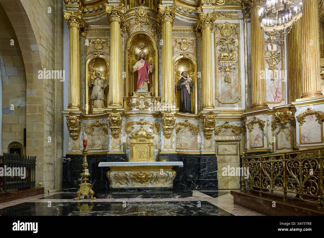 Ornate baroque altar inside a Catholic church featuring the Sacred Heart of Jesus at the center ...