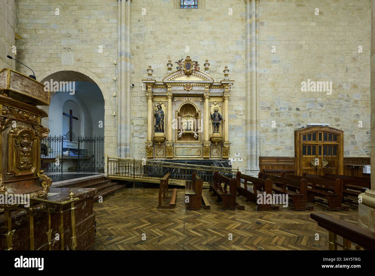Intricately decorated side altar, featuring statues of saints and a ...