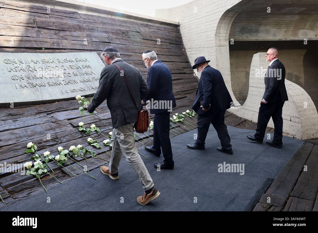 Representatives of the Jewish community lay flowers at the monument ...