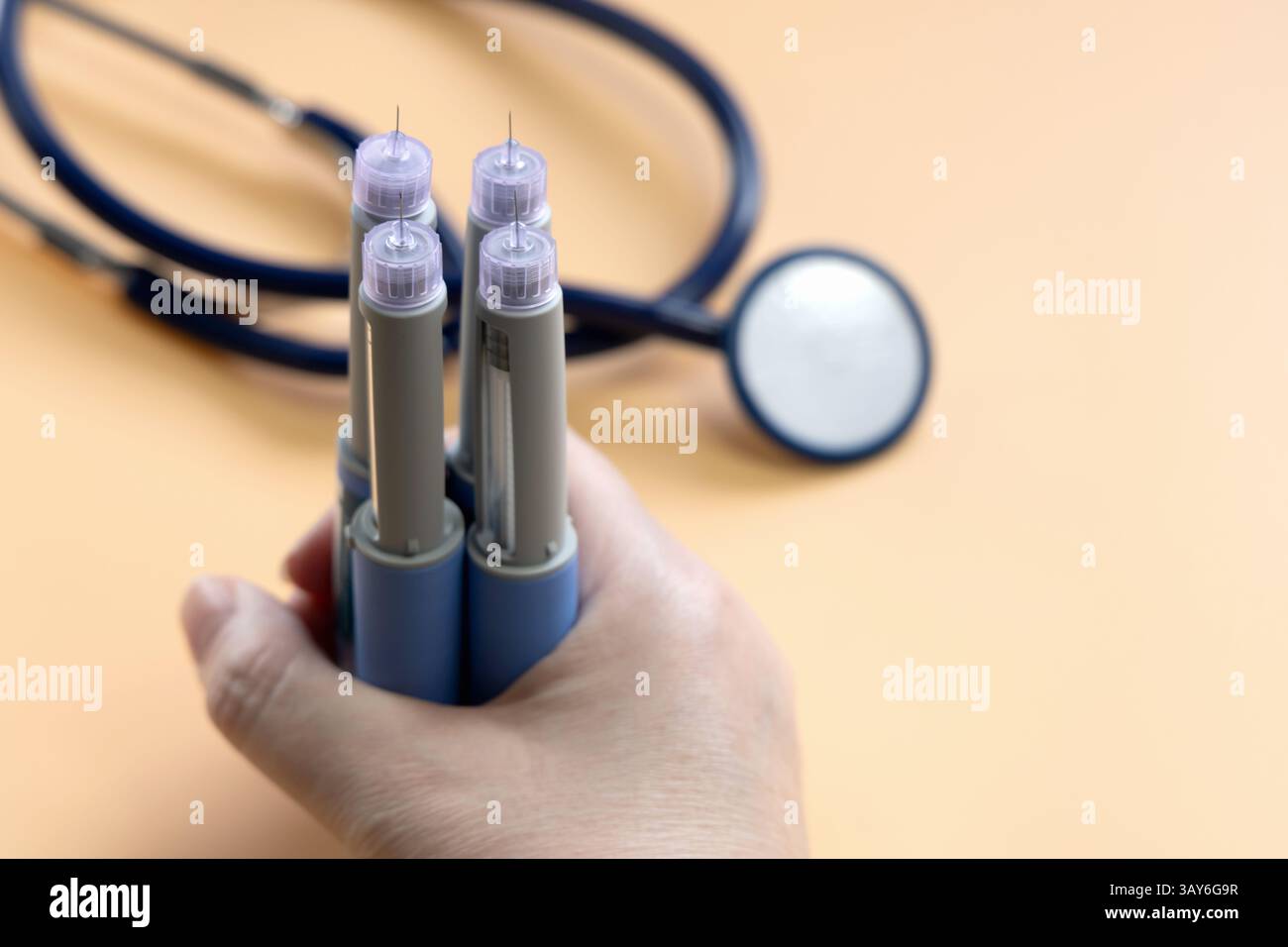 Women's hands holding blue Insulin injection pen for diabetics and ...