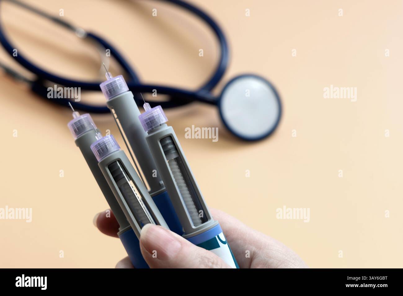 Women's hands holding blue Insulin injection pen for diabetics and ...