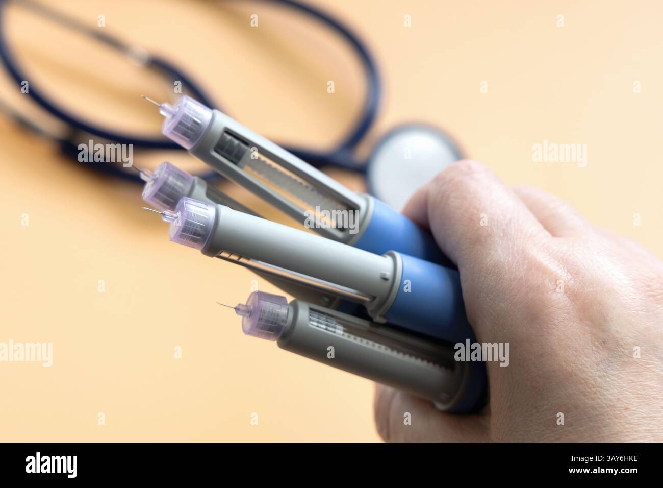 Women's hands holding blue Insulin injection pen for diabetics and ...