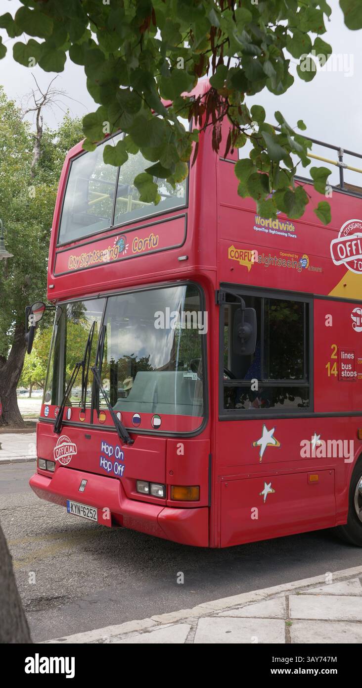 A tourist bus wait to take tourists on a guided tour of Corfu town ...