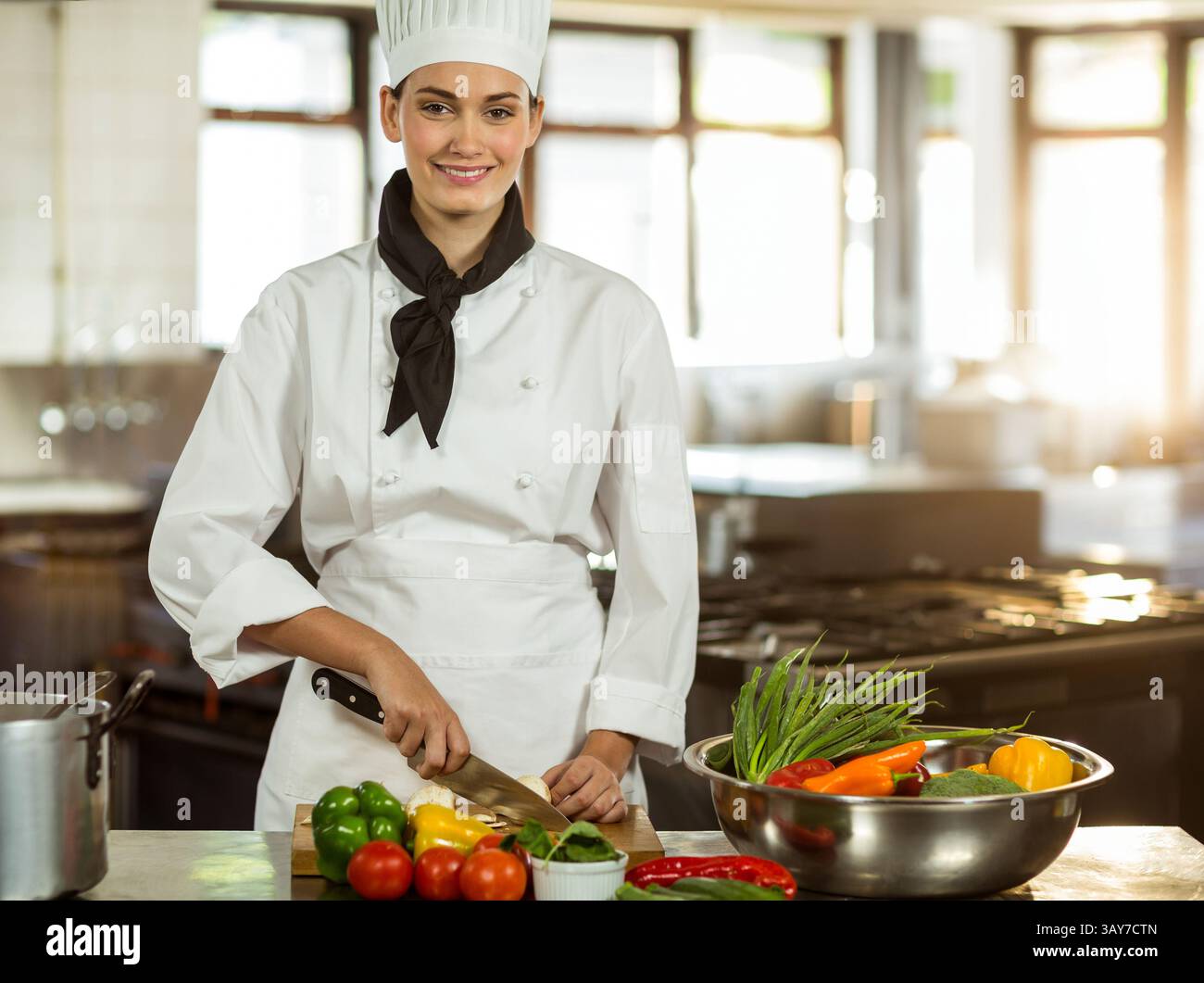 Portrait of female chef cutting vegetables in commercial kitchen Stock Photo - Alamy