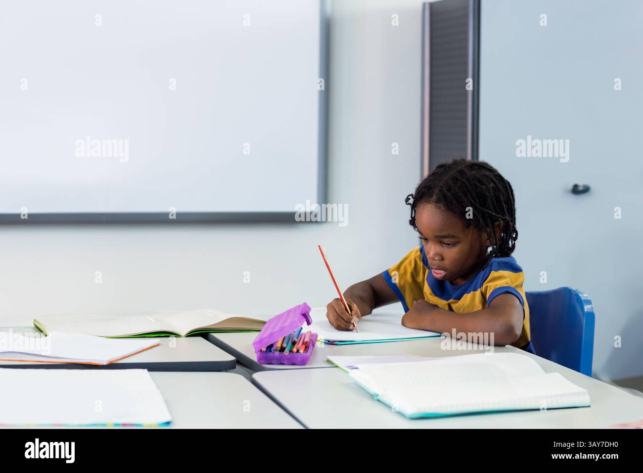 Child leaning over desk hi-res stock photography and images - Alamy