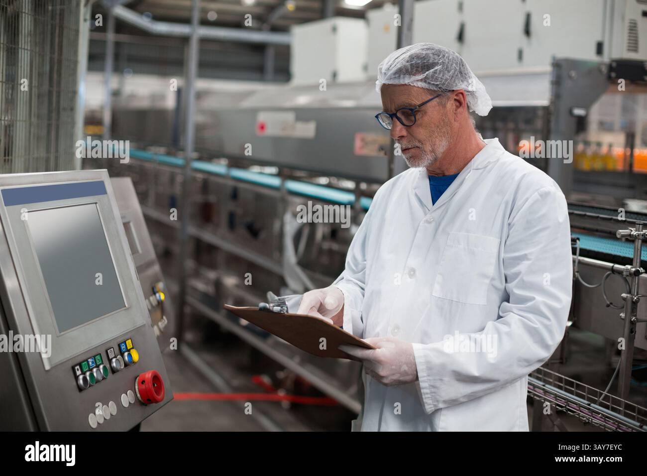 Senior QC inspector inspecting control panel at beverage factory ...